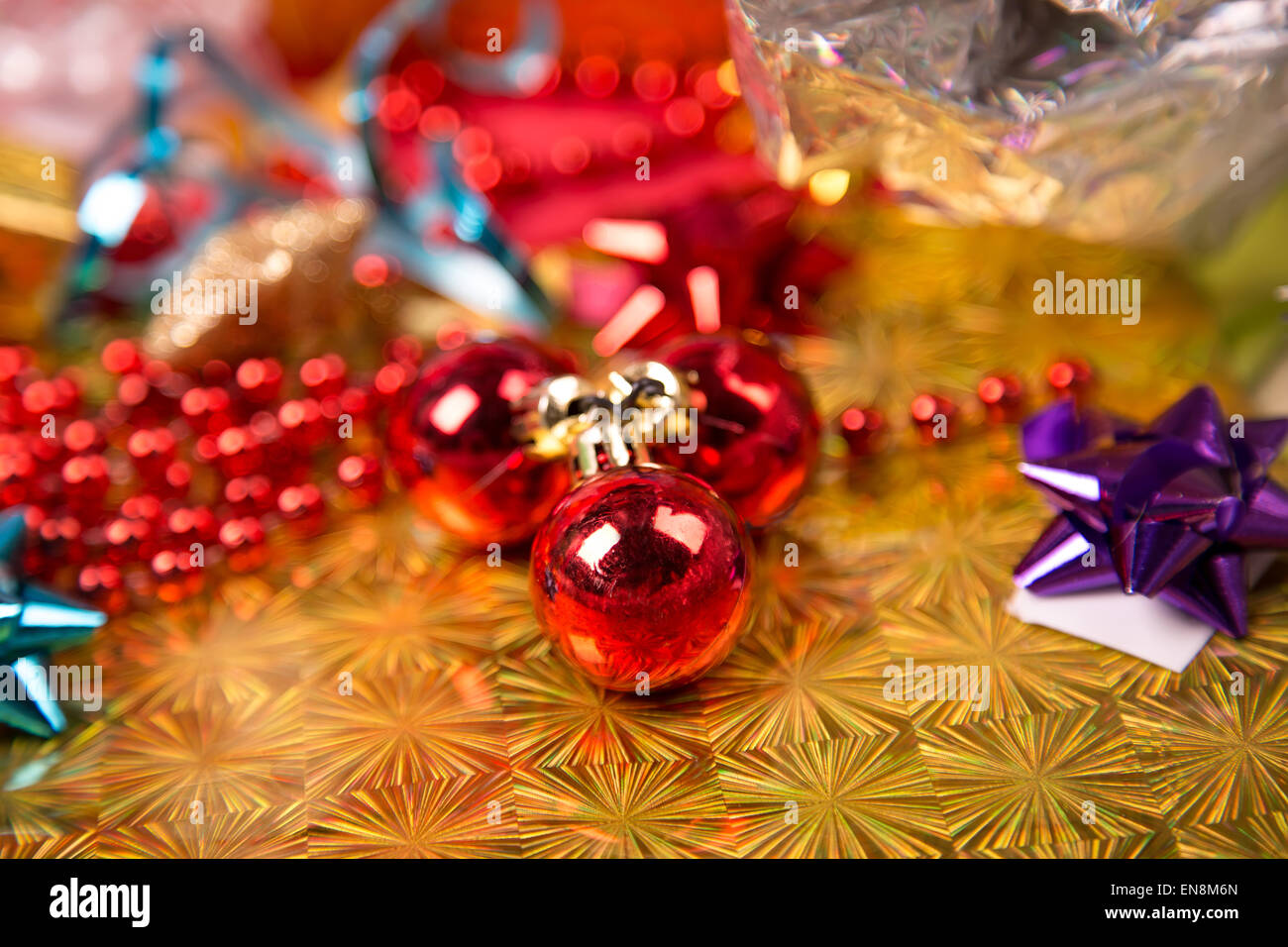 small red ball near golden gift-box red bead and bow close-up Stock ...
