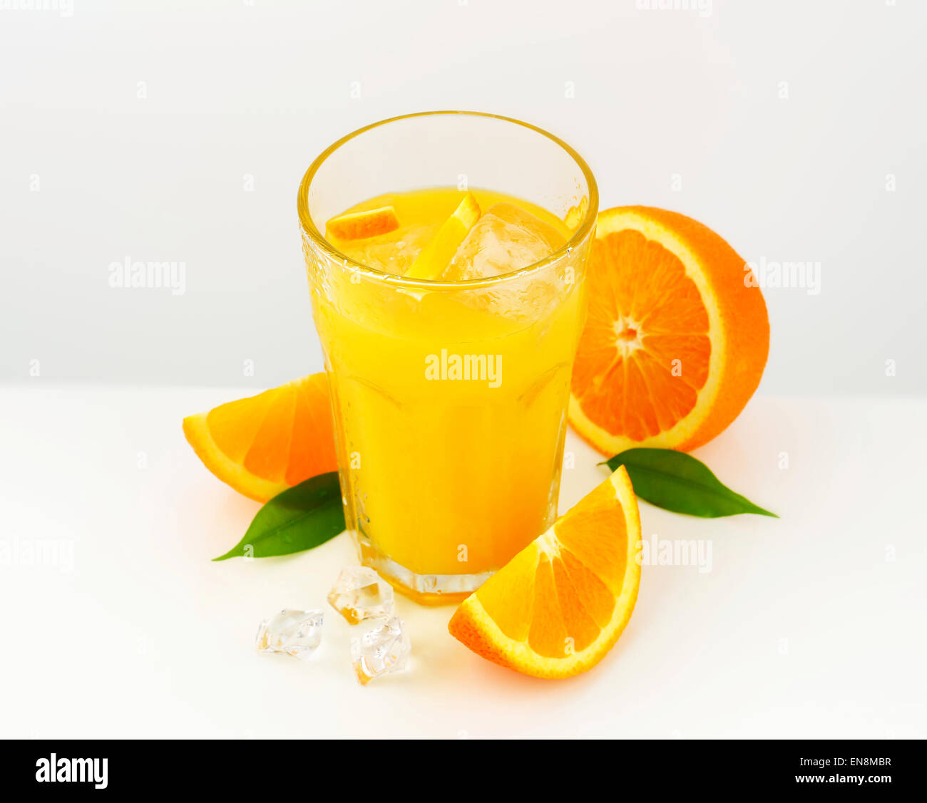 Glass of orange juice with ice Stock Photo - Alamy