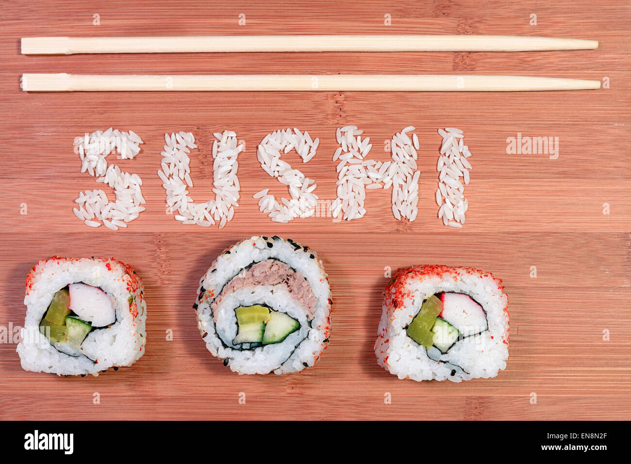 sushi pieces and sushi rice written on bamboo Stock Photo - Alamy