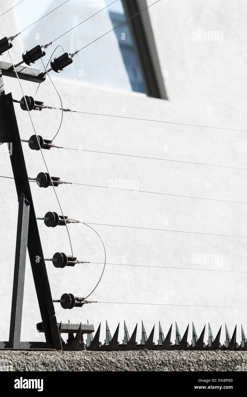 Electric fence alarm secure system on wall Stock Photo - Alamy