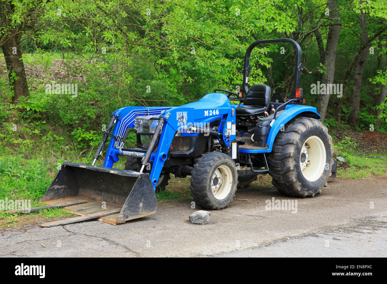 Blue Bush Hog TC400 tractor along a forest road Stock Photo - Alamy