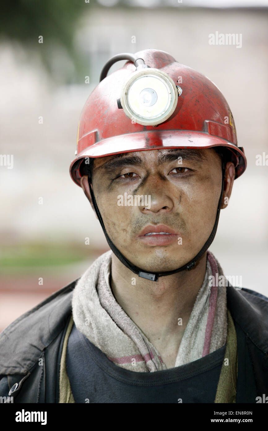 A coal miner with work clothes poses for photography at a coal mine in ...
