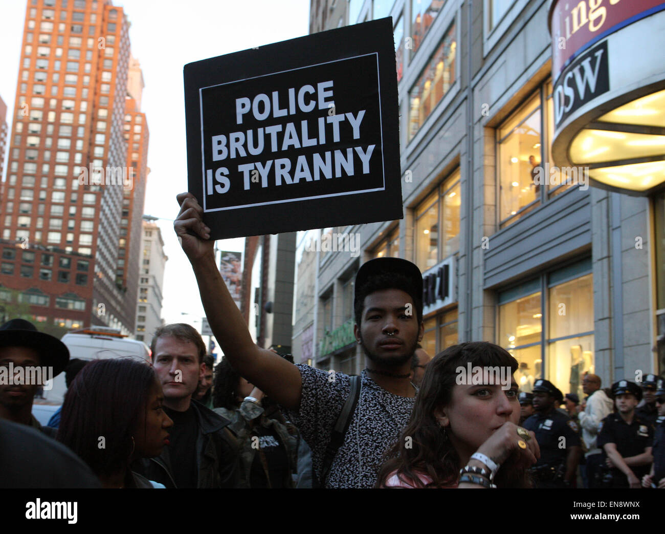 New York, USA. 29th Apr, 2015. A protestor holding a placard marches ...