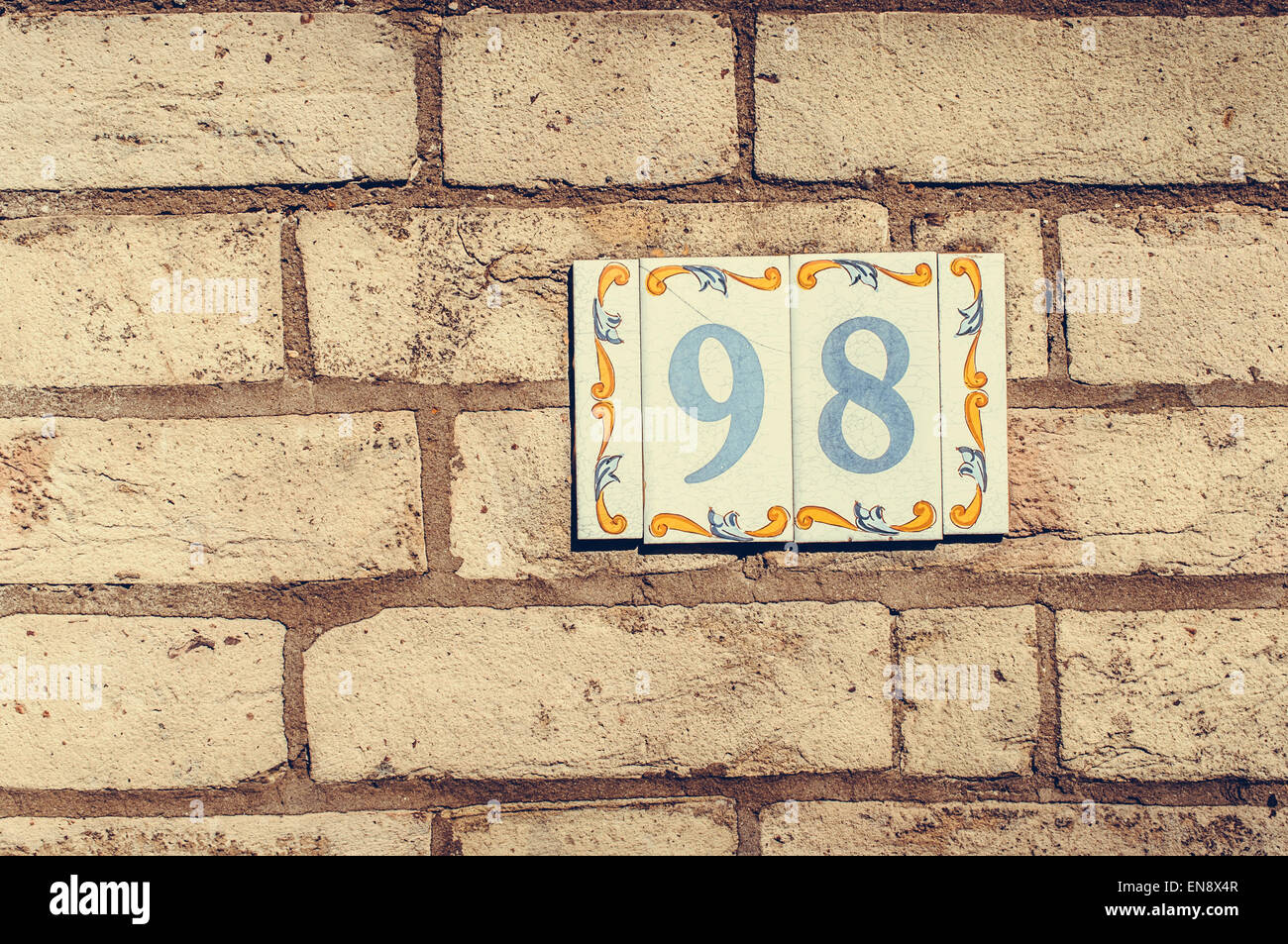 House number ninety eight on a brick wall for use as a background Stock ...