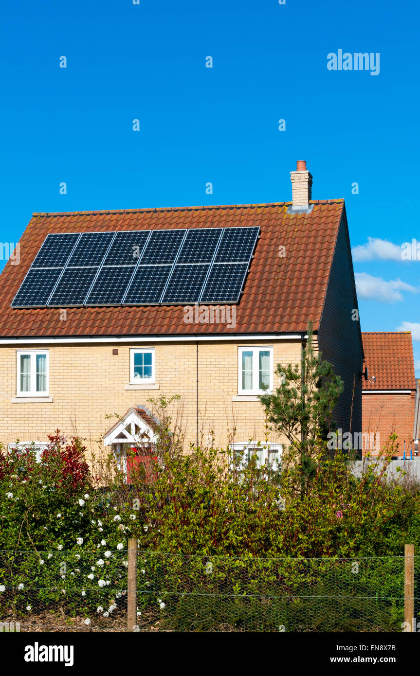 Modern Solar photovoltaic panel array on house roof against a blue sky ...