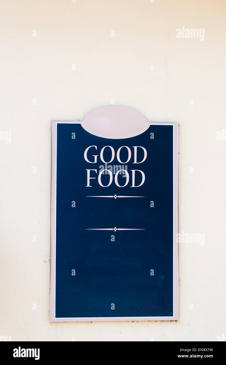 Restaurant sign advertising 'Good Food' on a wall Stock Photo - Alamy