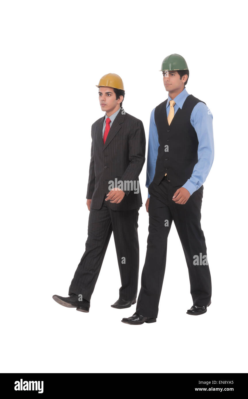 Two asian professional men walking together, wearing helmets Stock ...