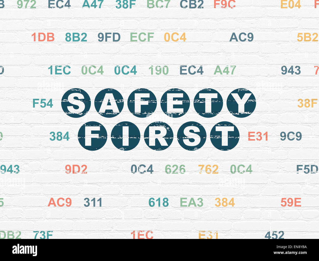 Security concept: Safety First on wall background Stock Photo - Alamy