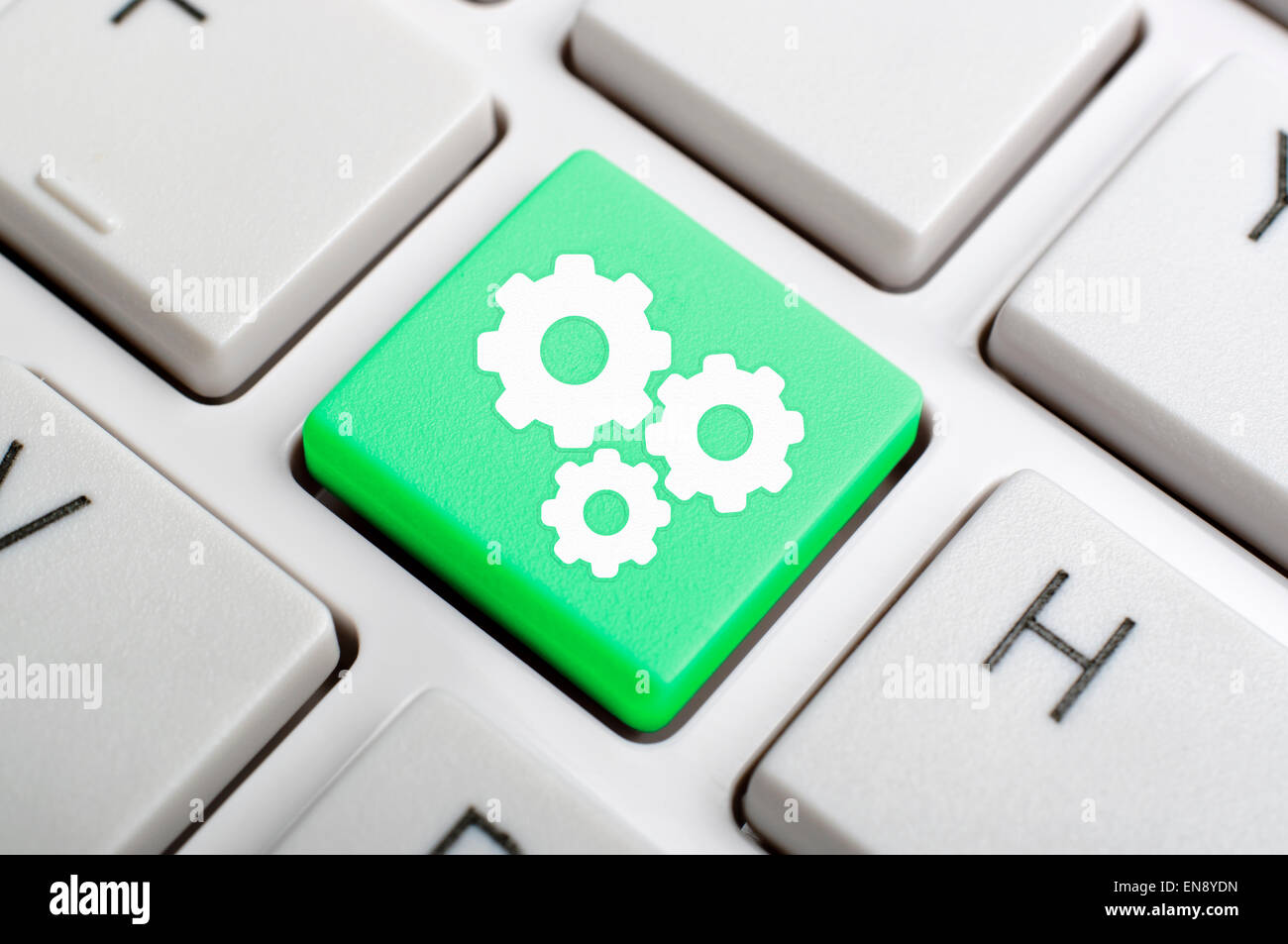 Three gears key on keyboard, abstract teamwork concept Stock Photo - Alamy