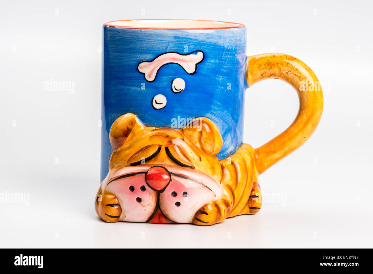 Yellow ceramic mug with dog on white background Stock Photo - Alamy
