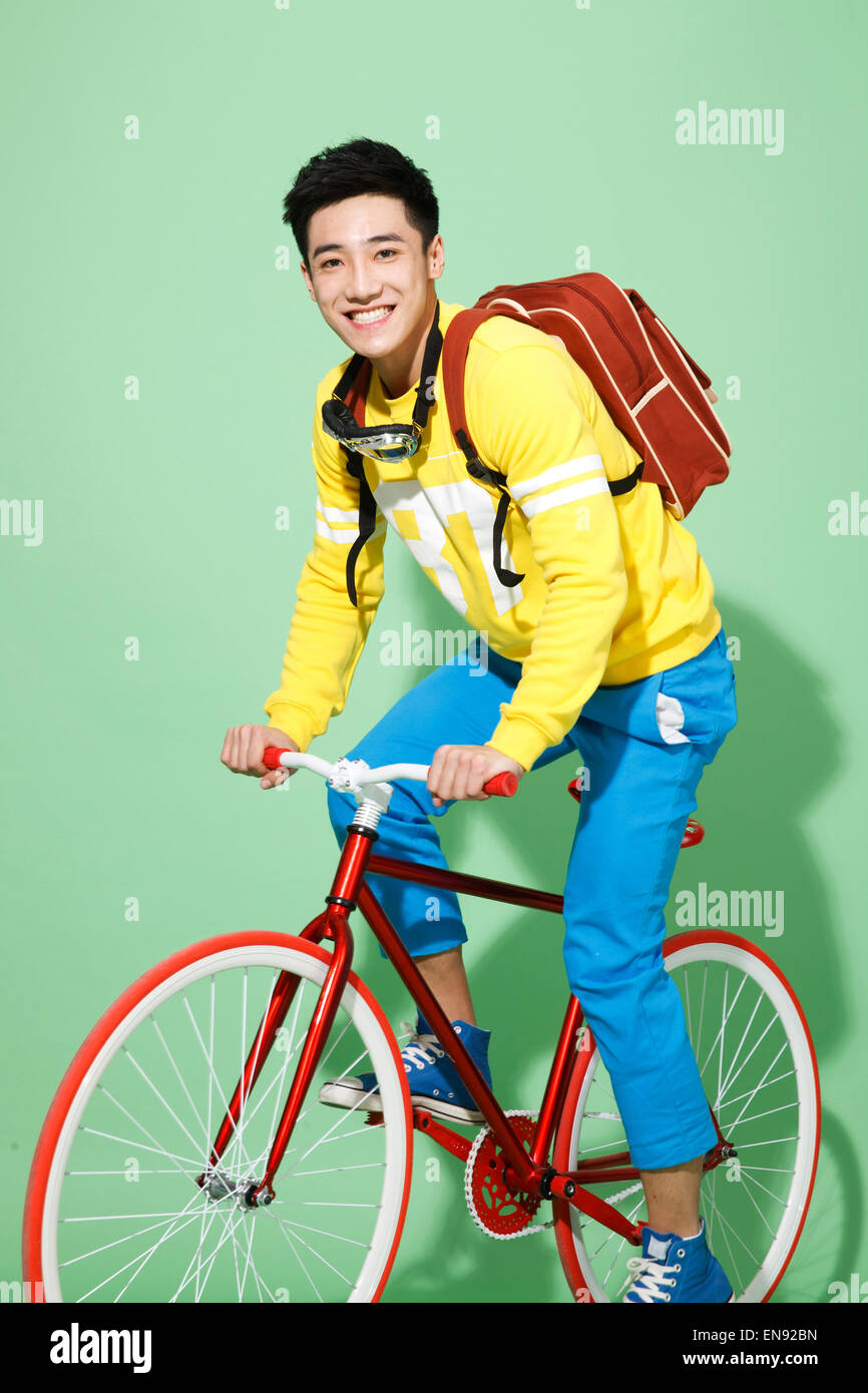 The stylish young man riding a bicycle Stock Photo - Alamy