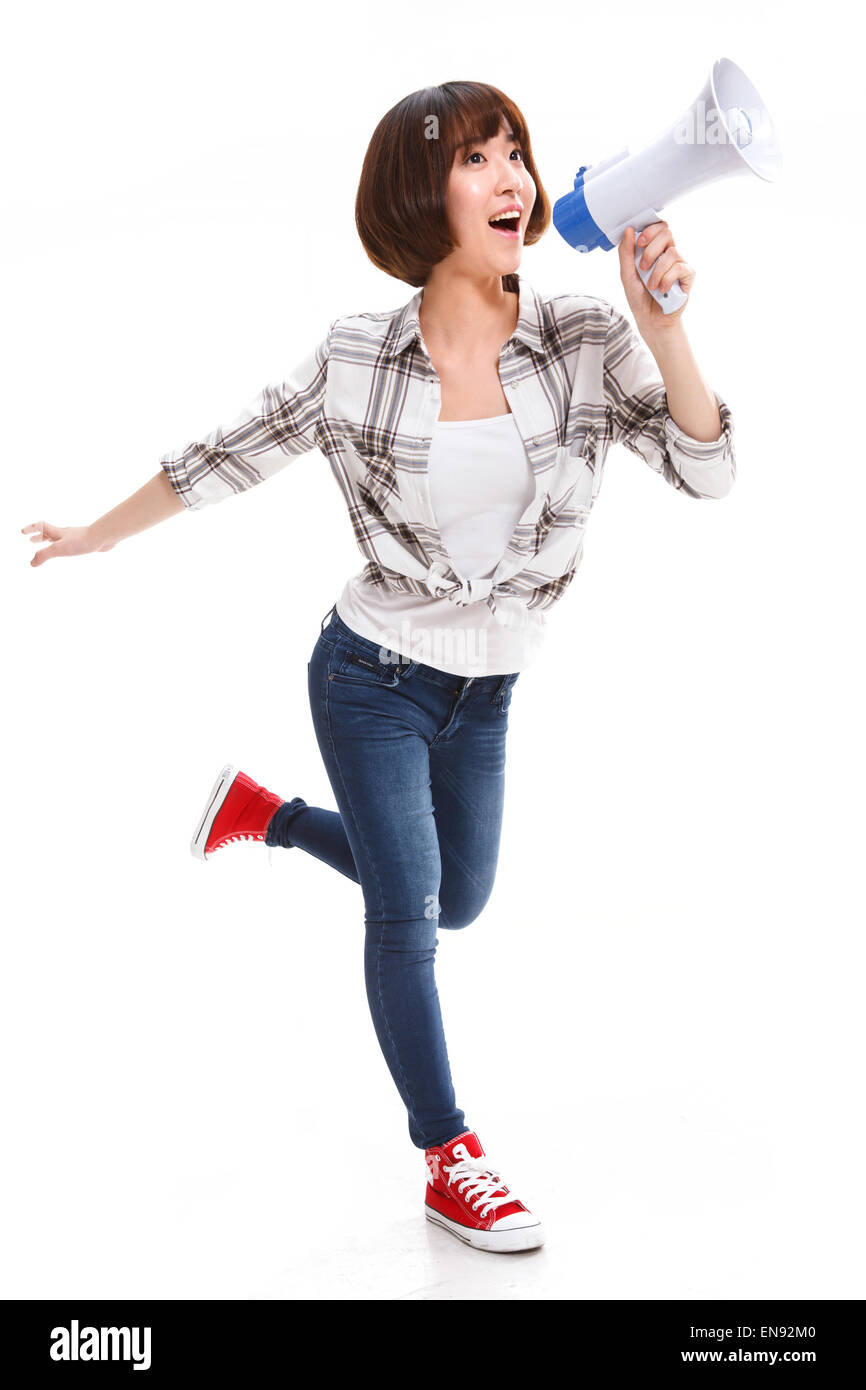 The young woman holding a microphone to shout Stock Photo - Alamy