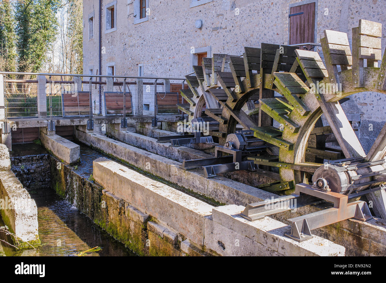 Series of three wheeled wooden mill renovated Stock Photo - Alamy