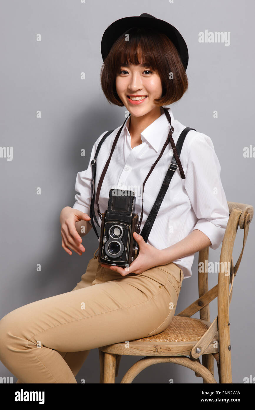 Beautiful young woman with a camera Stock Photo - Alamy