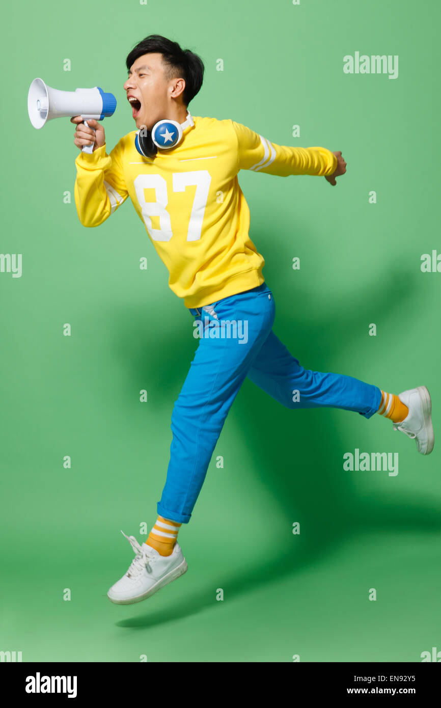 The young man took the microphone to shout Stock Photo - Alamy