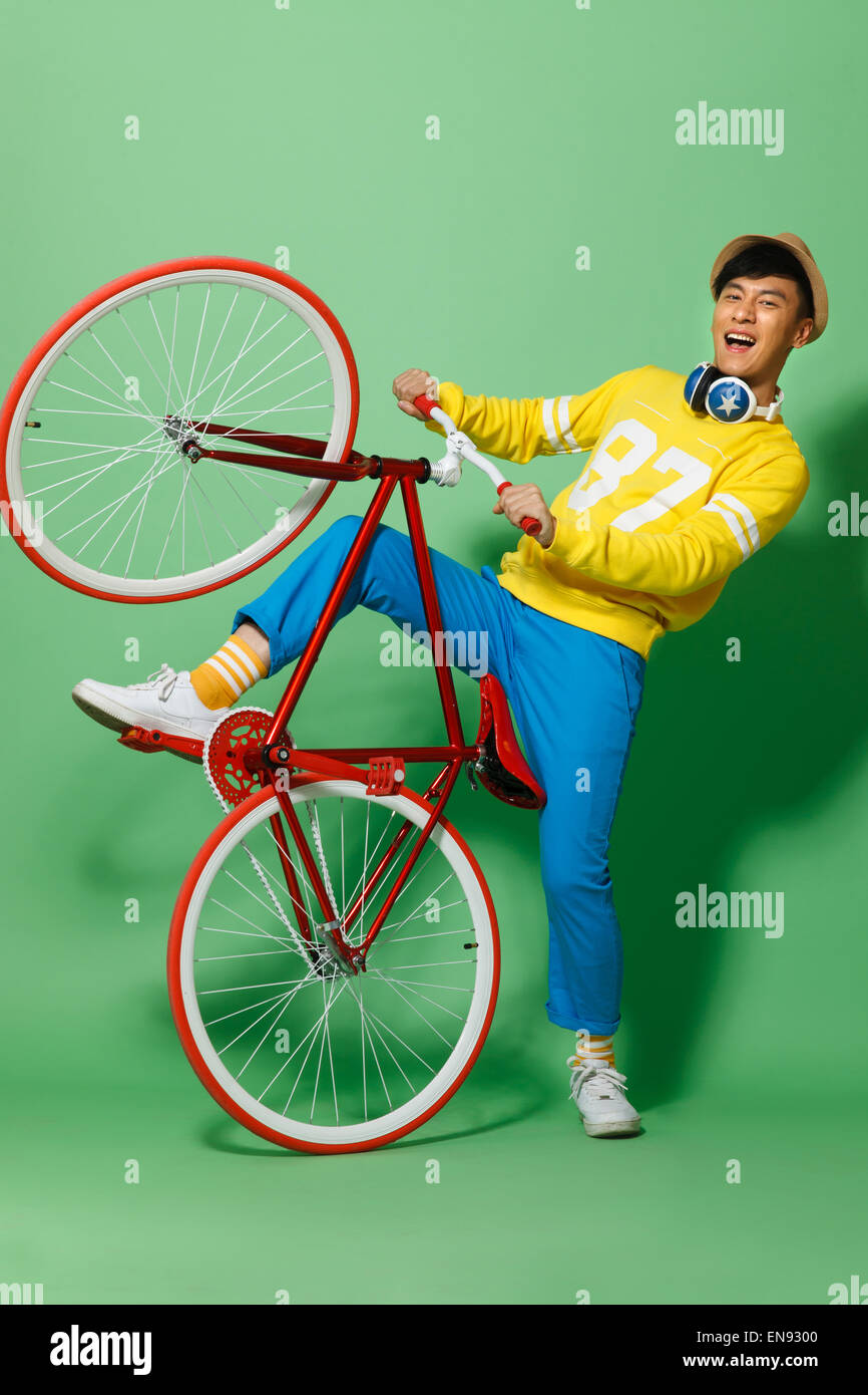 Young guy riding a bicycle Stock Photo - Alamy