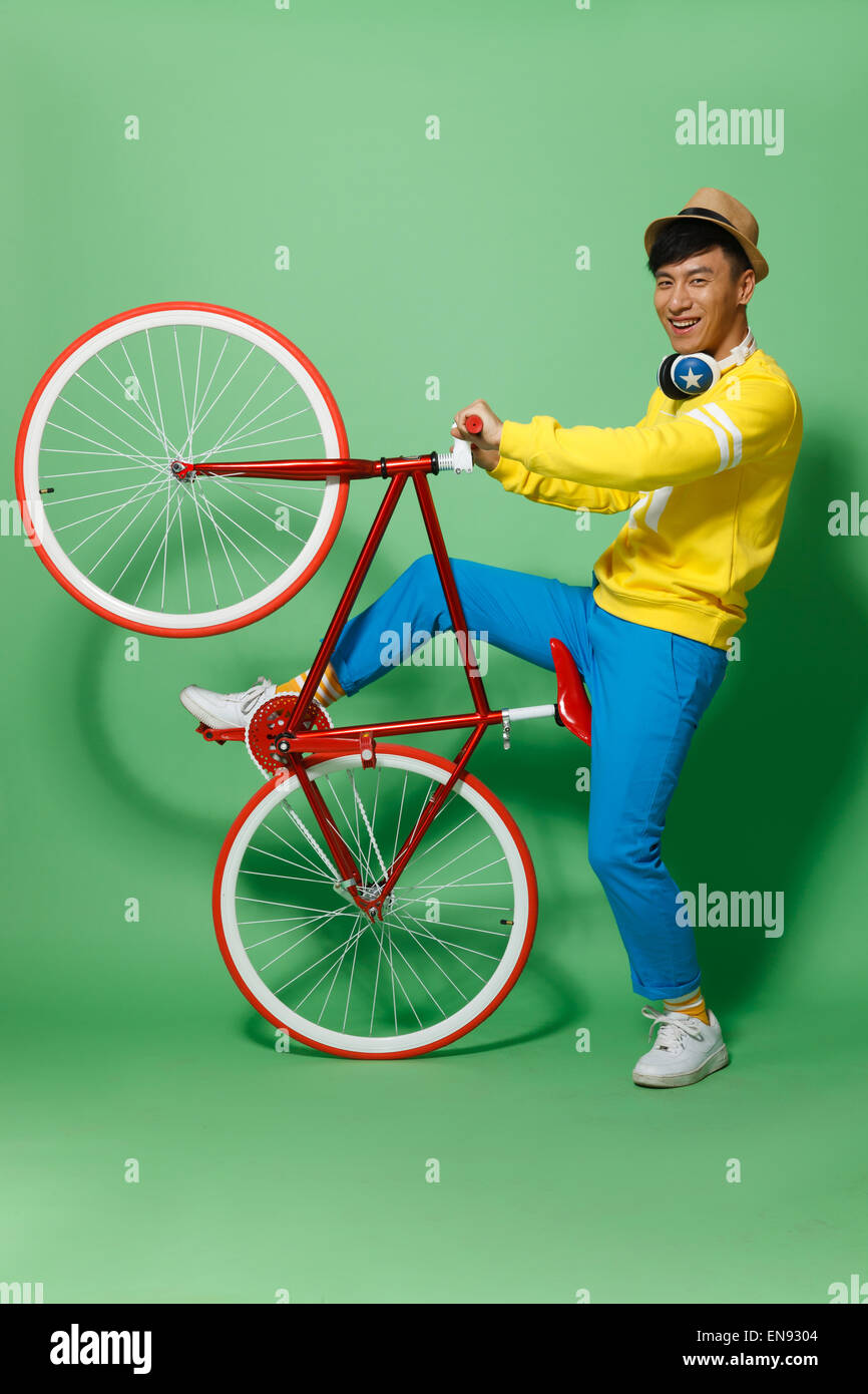 Young guy riding a bicycle Stock Photo - Alamy