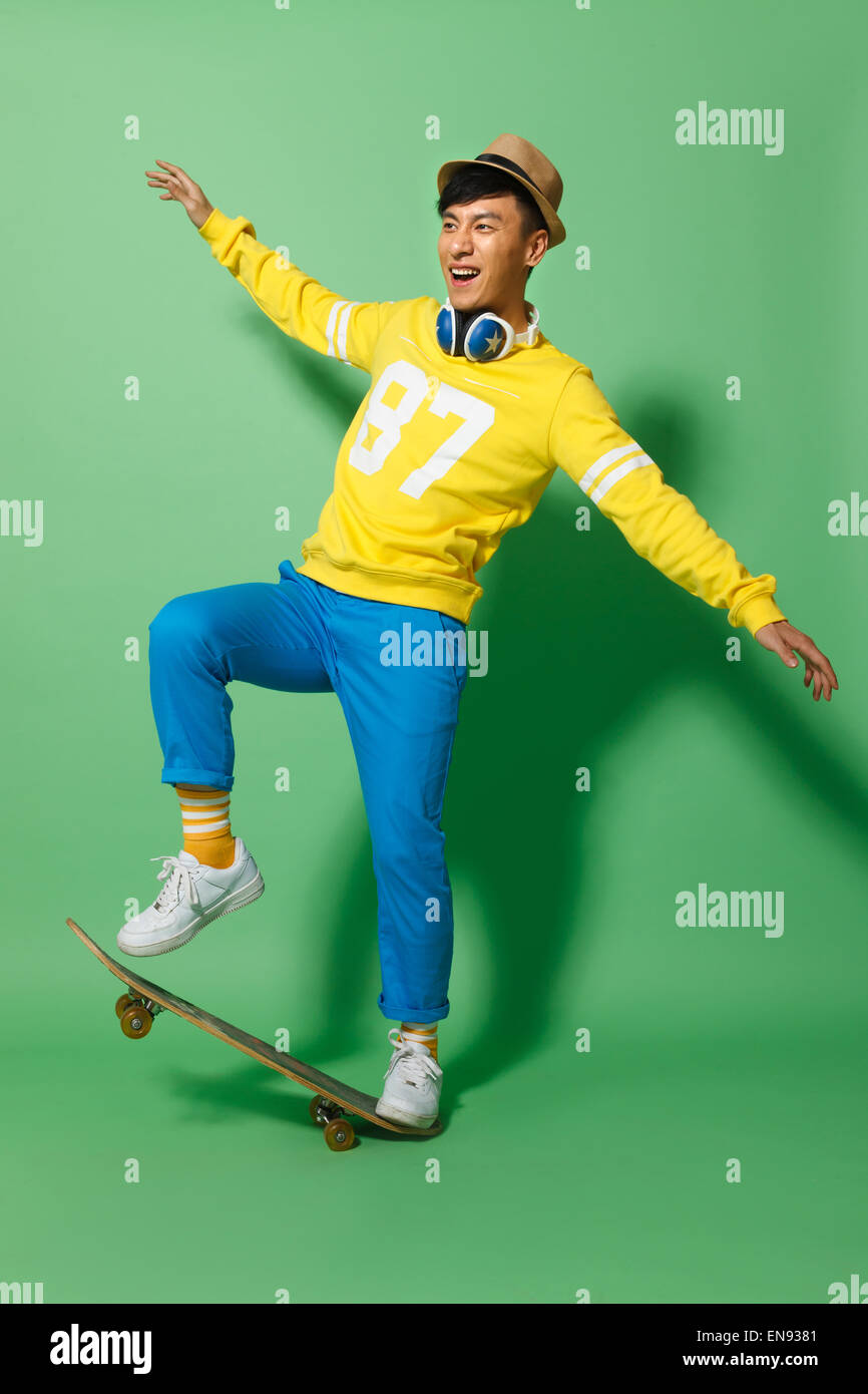 Young guy playing skateboard Stock Photo - Alamy