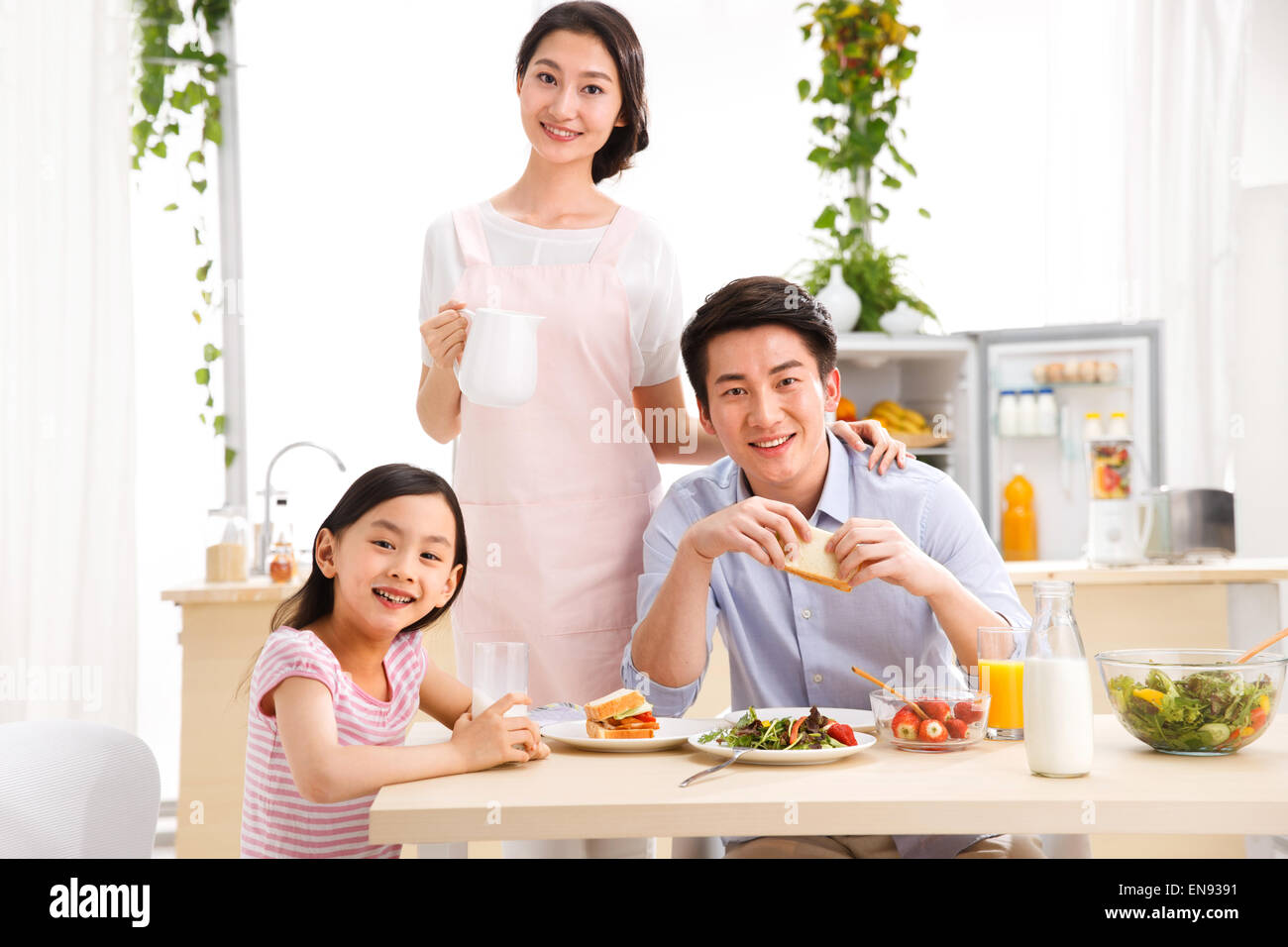 Family having breakfast at home Stock Photo - Alamy