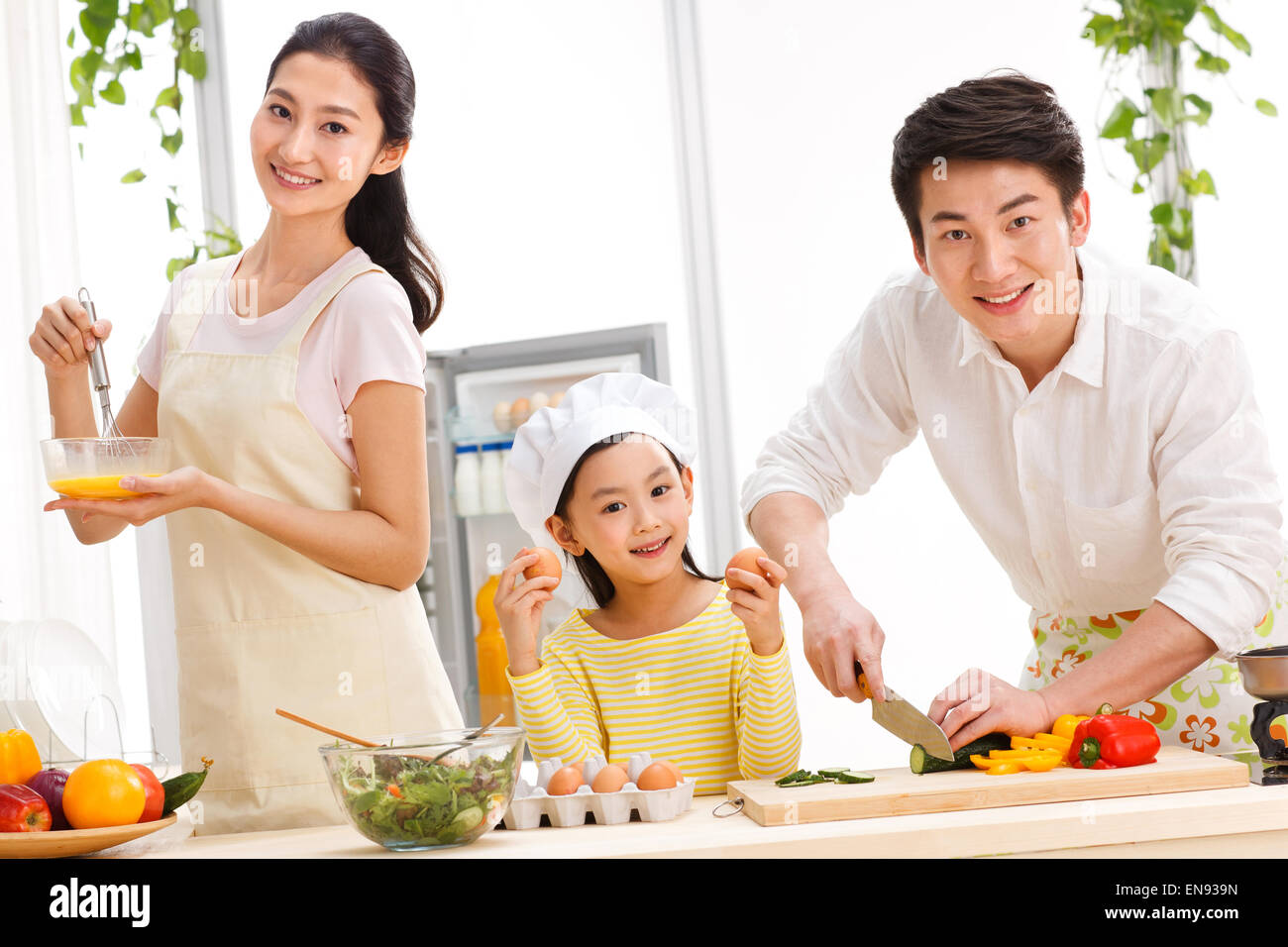 Family preparing food in kitchen Stock Photo - Alamy