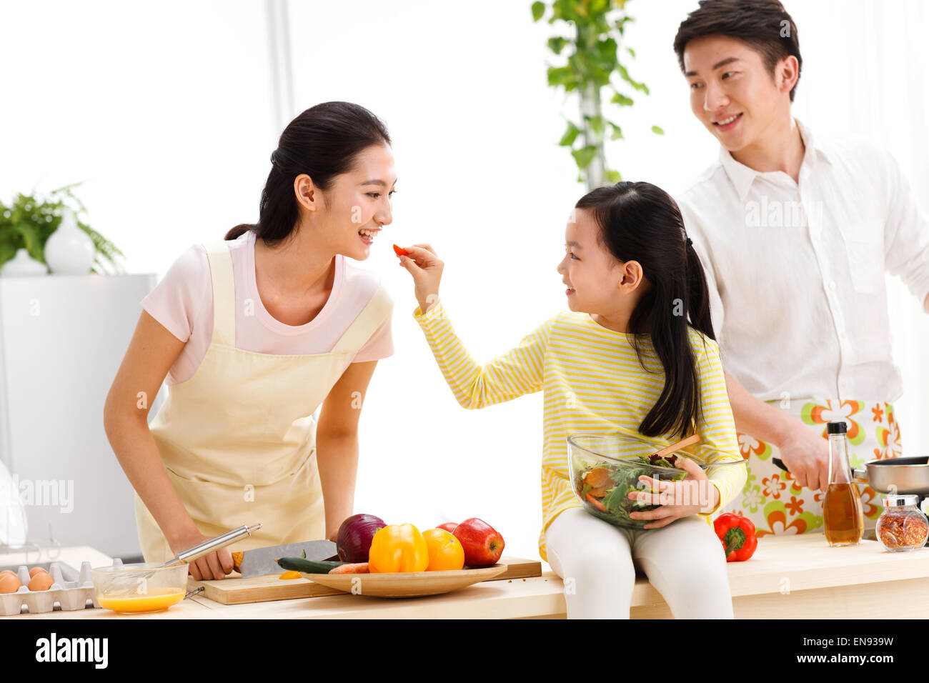 Family preparing food in kitchen Stock Photo - Alamy