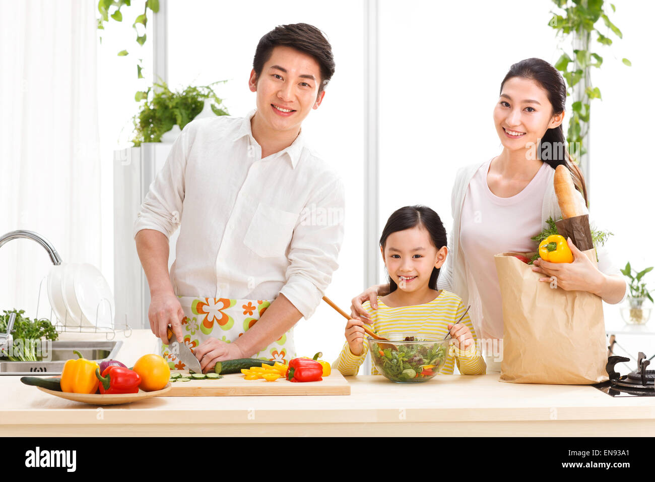 Family preparing food in kitchen Stock Photo - Alamy