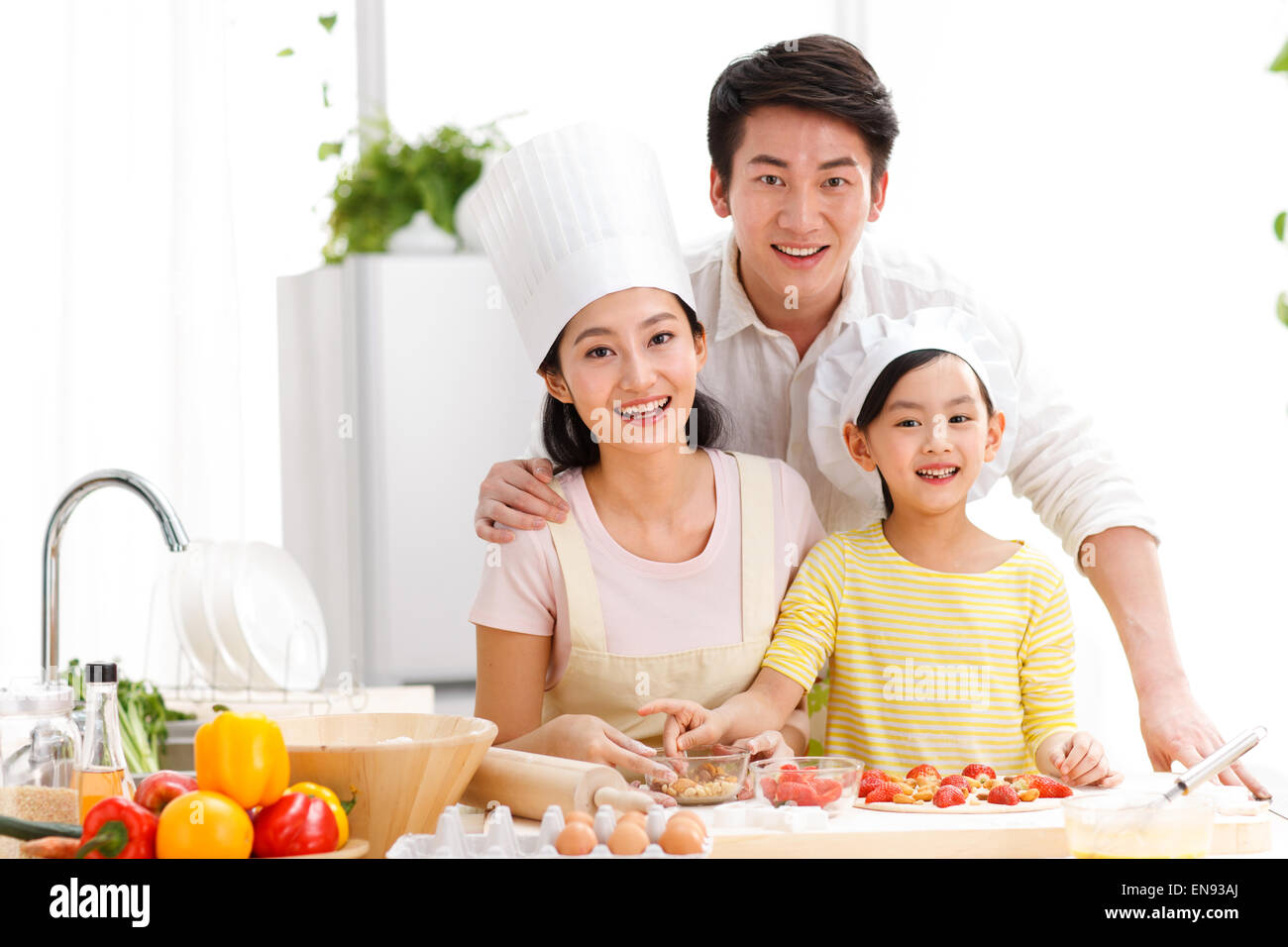 Family preparing food in kitchen Stock Photo - Alamy