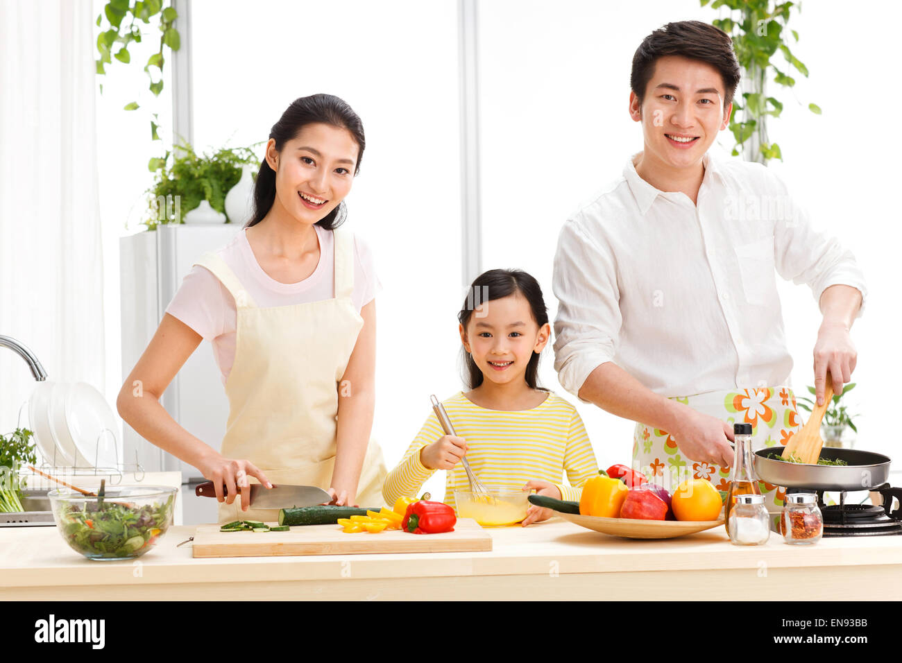 Family preparing food in kitchen Stock Photo - Alamy