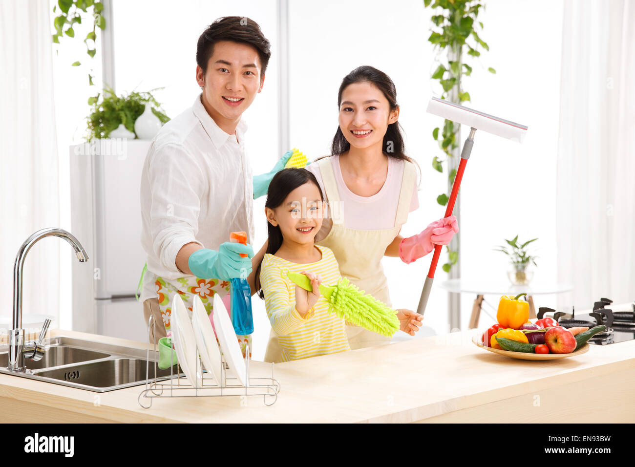 Family doing cleaning-up in kitchen Stock Photo - Alamy