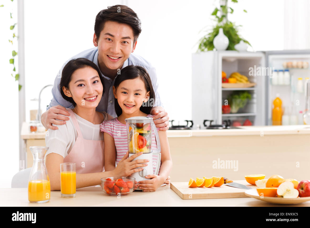 Family in kitchen preparing drink Stock Photo - Alamy