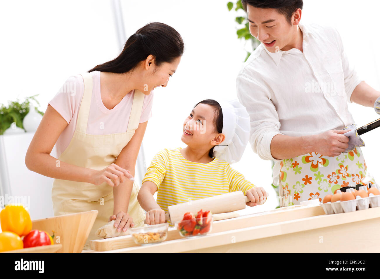 Family preparing food in kitchen Stock Photo - Alamy
