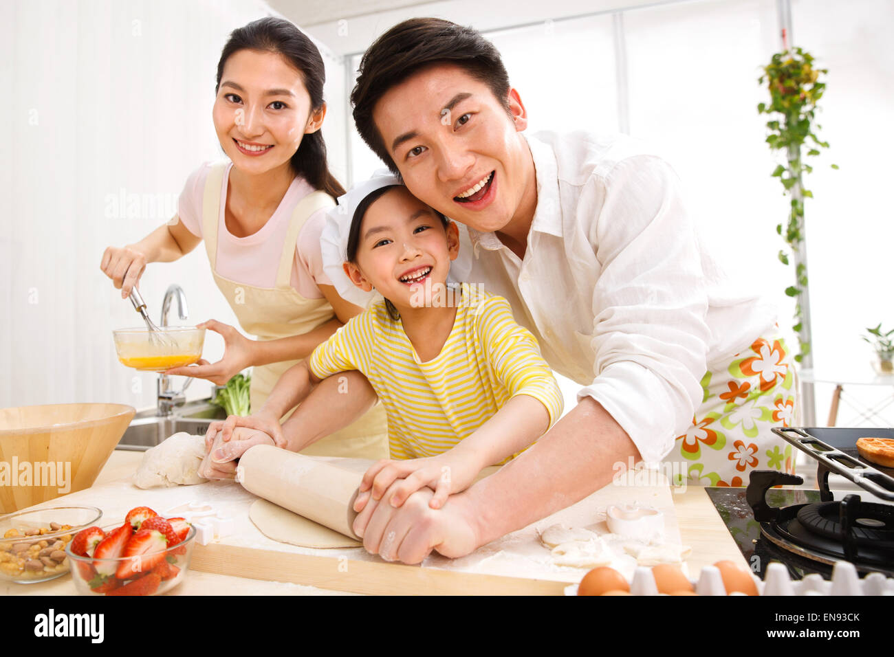 Family preparing food in kitchen Stock Photo - Alamy