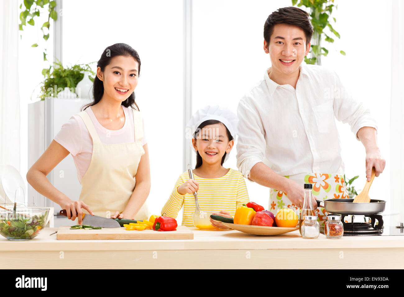 Family preparing food in kitchen Stock Photo - Alamy