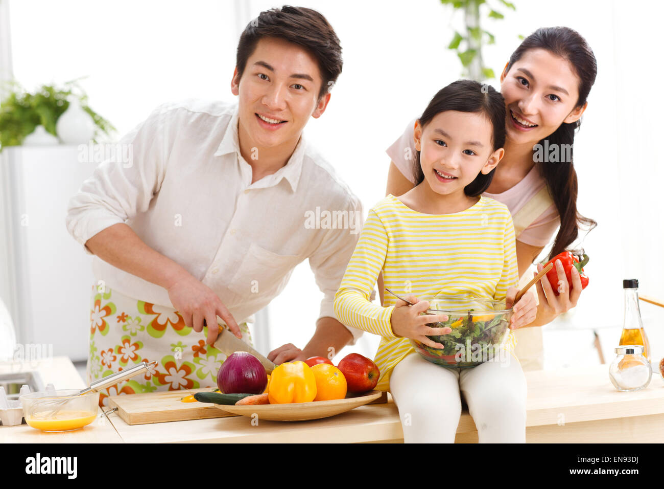 Family preparing food in kitchen Stock Photo - Alamy