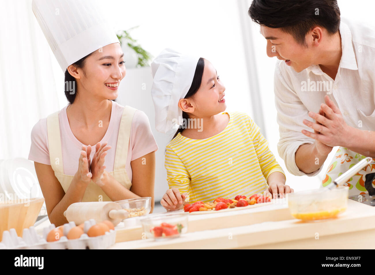 Family preparing food in kitchen Stock Photo - Alamy