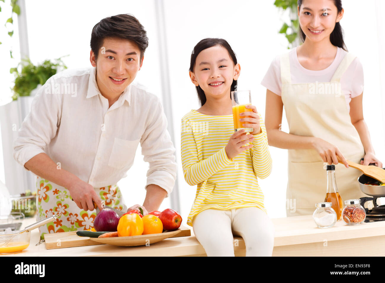 Family preparing food in kitchen Stock Photo - Alamy