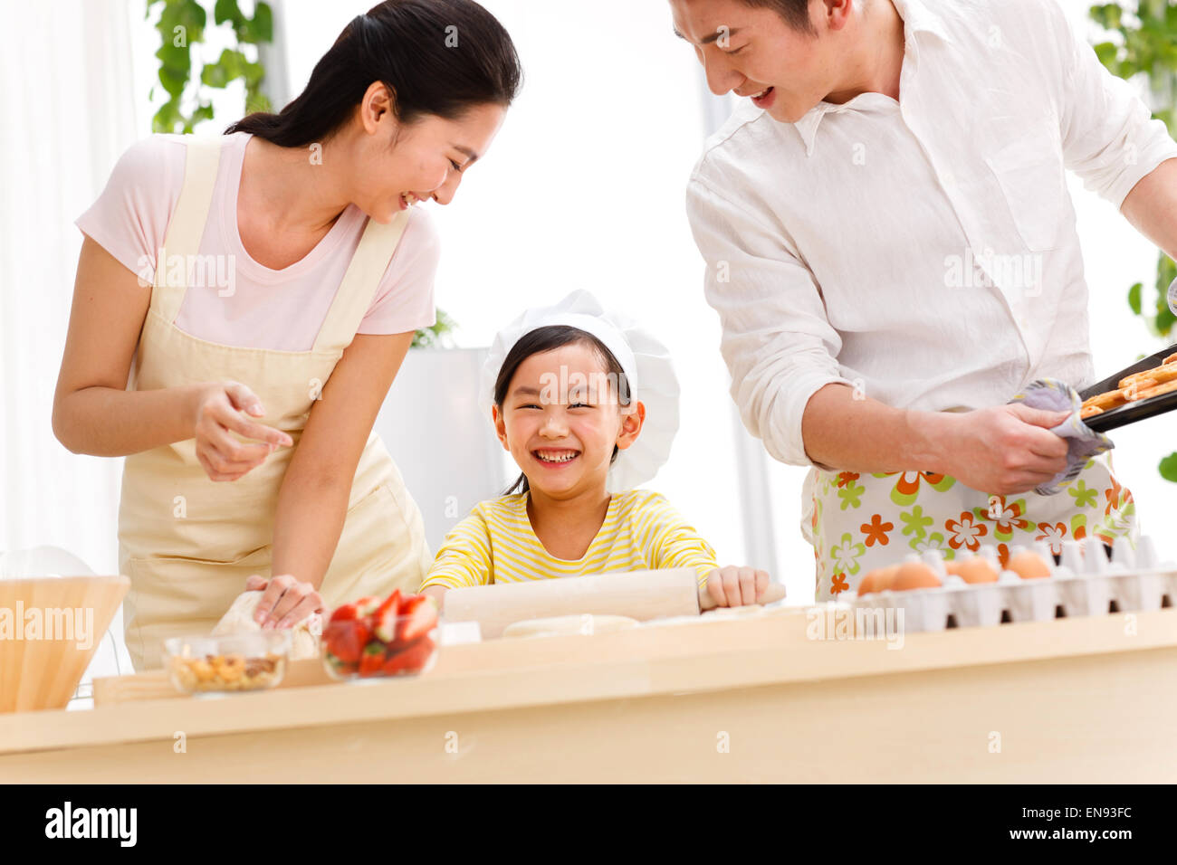 Family preparing food in kitchen Stock Photo - Alamy