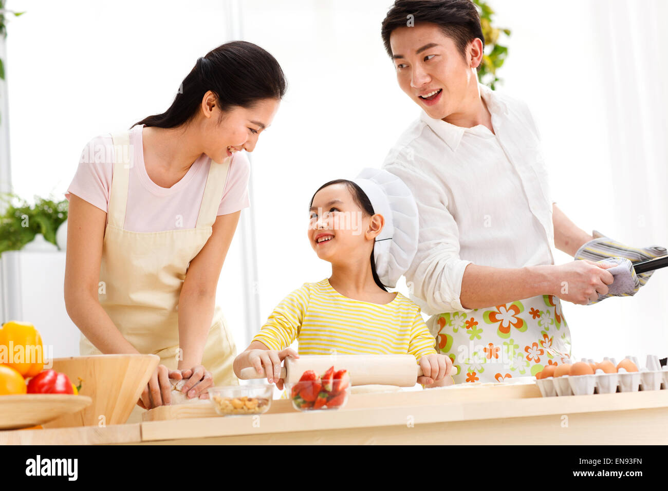Family preparing food in kitchen Stock Photo - Alamy