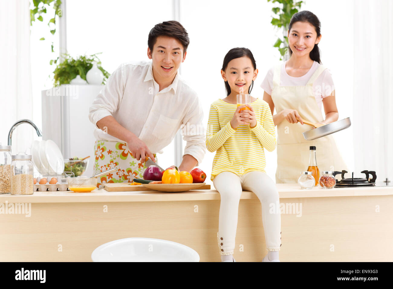 Family preparing food in kitchen Stock Photo - Alamy