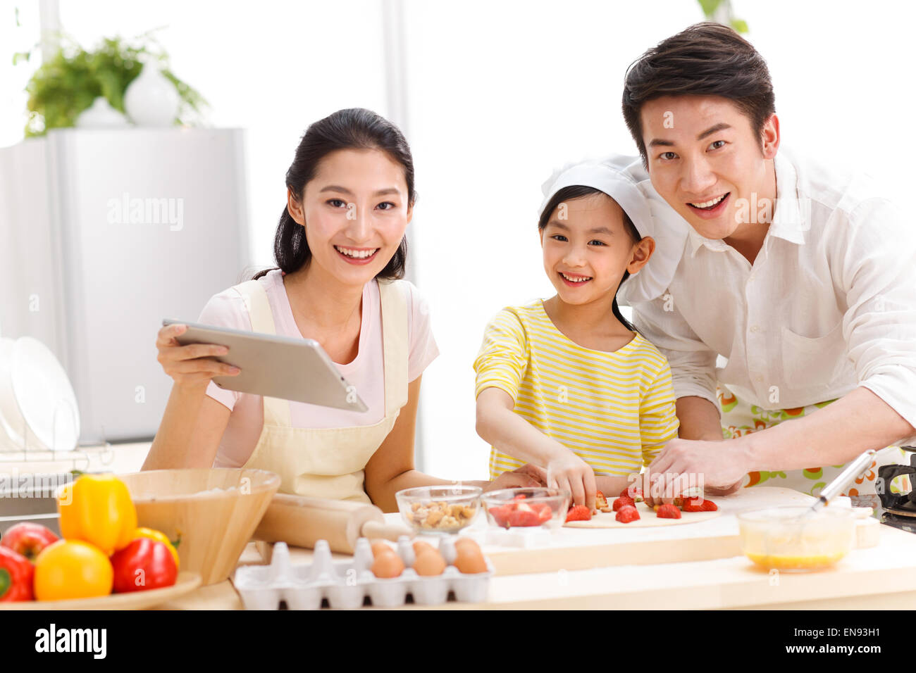Family preparing food in kitchen Stock Photo - Alamy