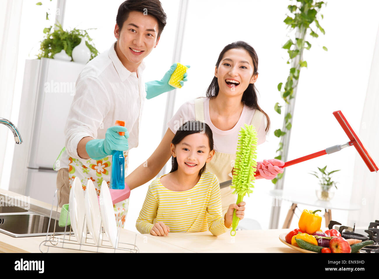 Family doing cleaning-up in kitchen Stock Photo - Alamy