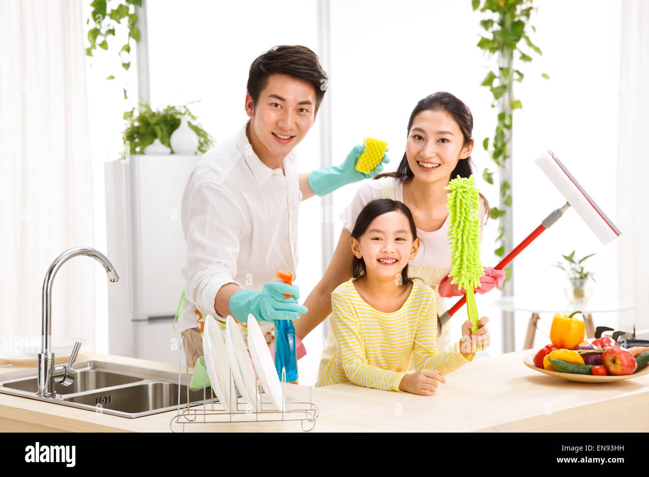 Family doing cleaning-up in kitchen Stock Photo - Alamy