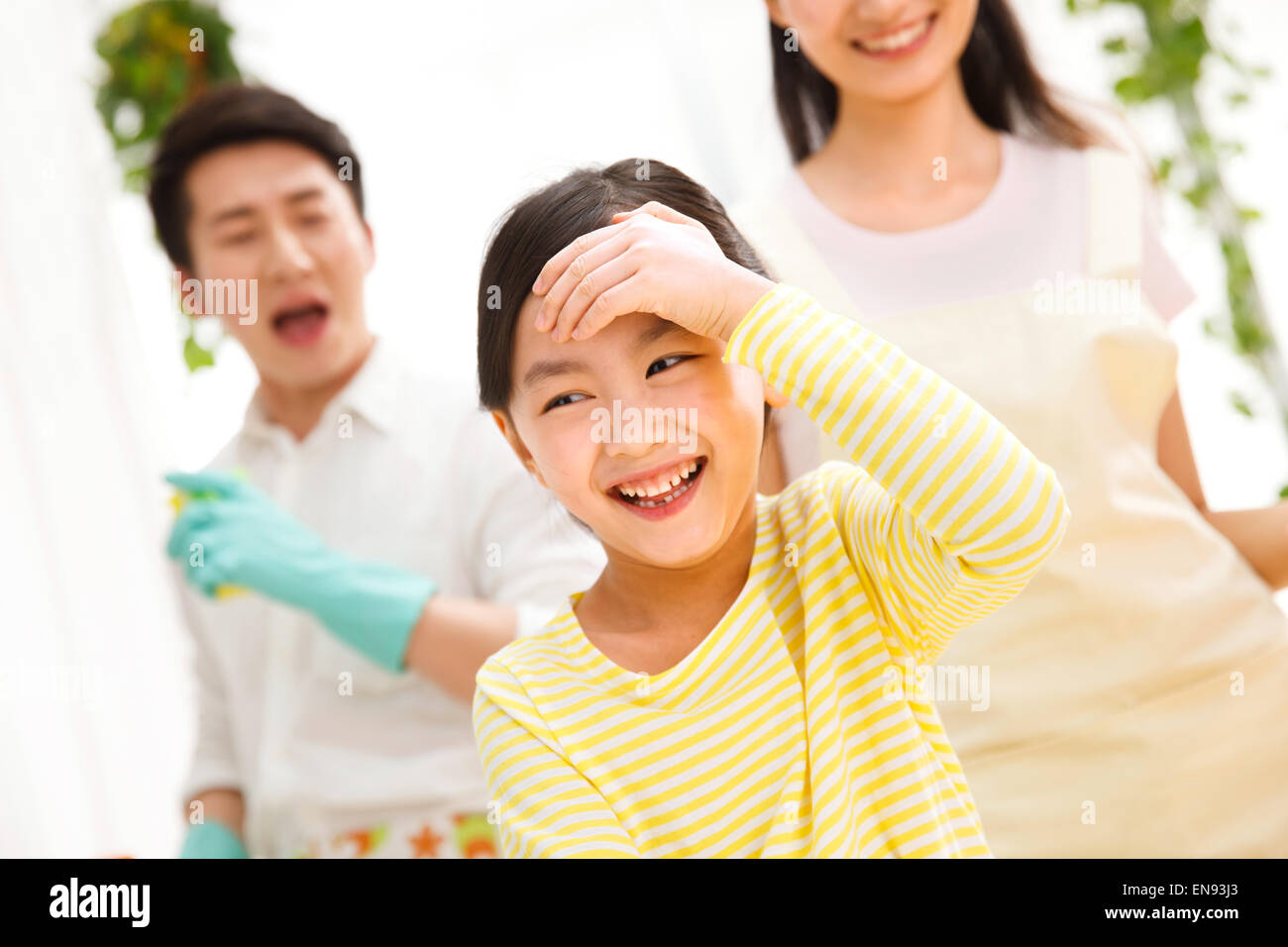 Family doing cleaning-up in kitchen Stock Photo - Alamy