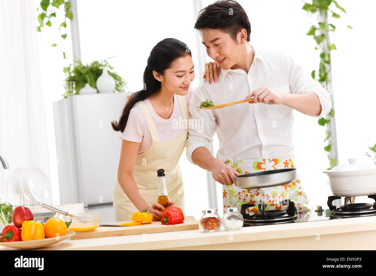 Couple preparing food in kitchen Stock Photo - Alamy