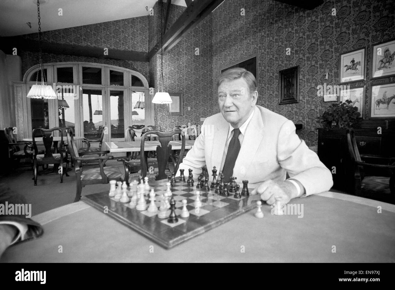 John Wayne who recently starred in 'Brannigan' at home in Texas playing ...