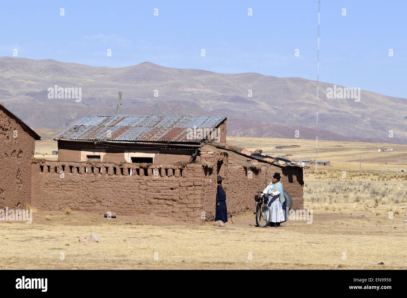 Woman nest to a house in Bolivia Stock Photo - Alamy