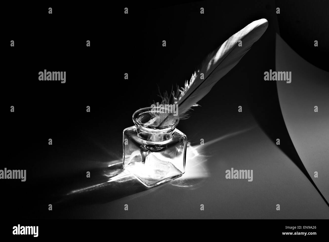 Black feather and ink pot Stock Photo - Alamy
