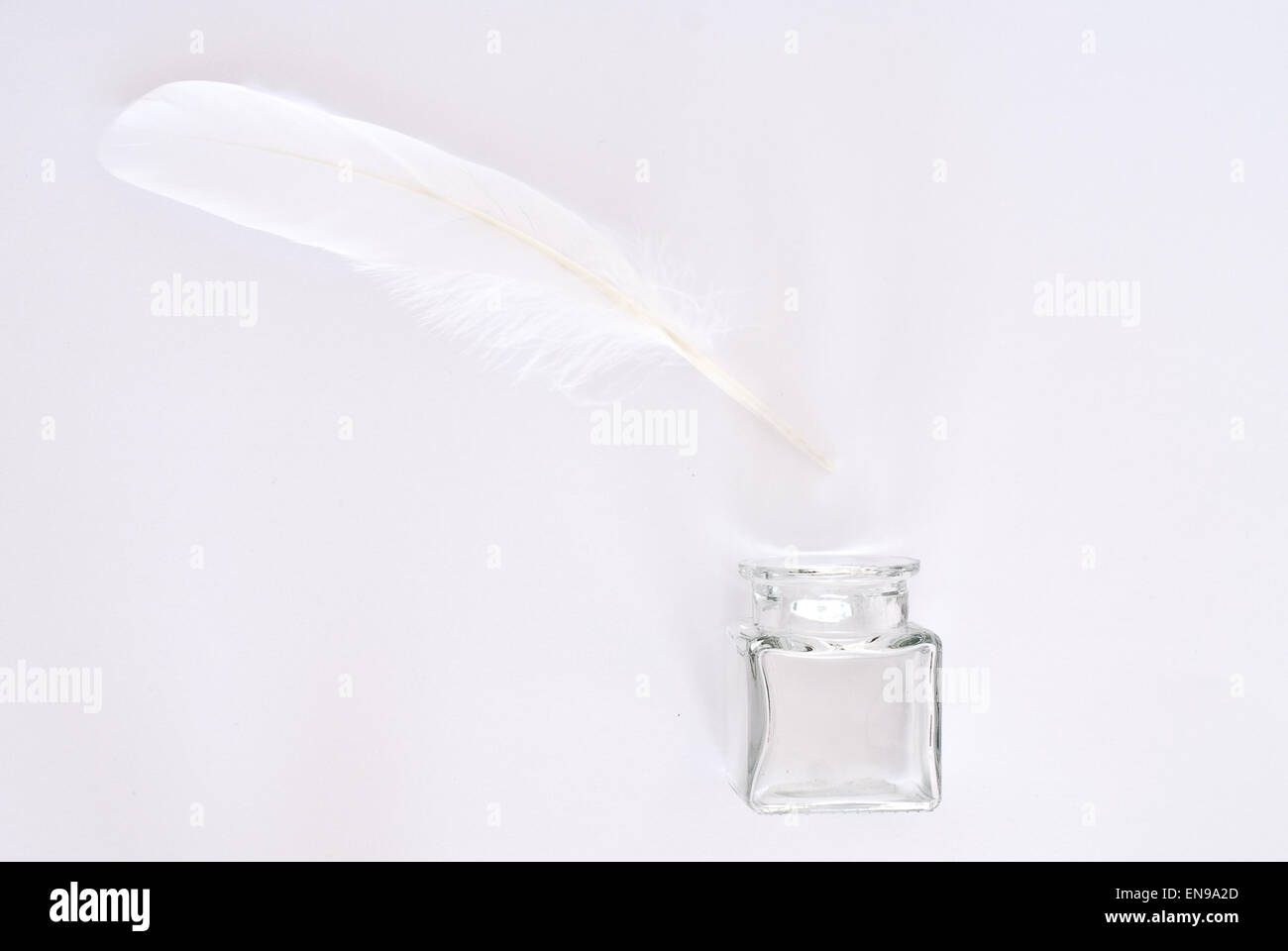 White feather on white background and ink pot Stock Photo - Alamy