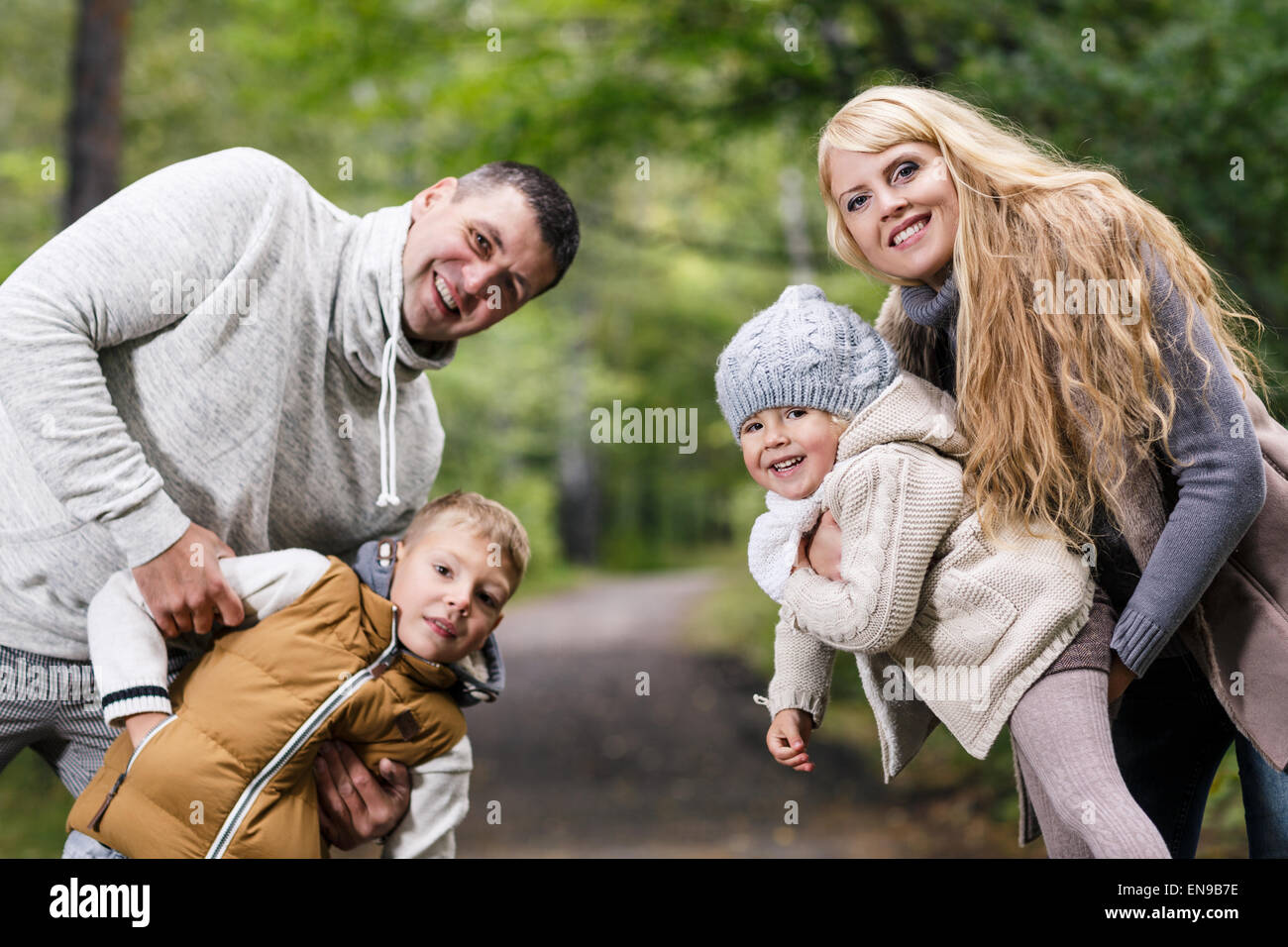 Family in the autumn park Stock Photo - Alamy