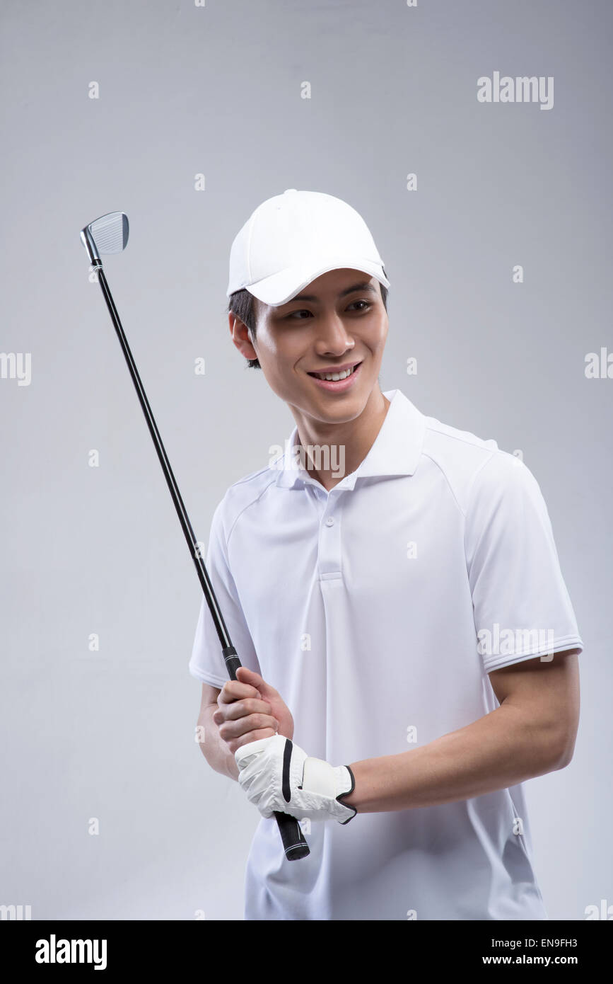 Young man playing golf Stock Photo - Alamy